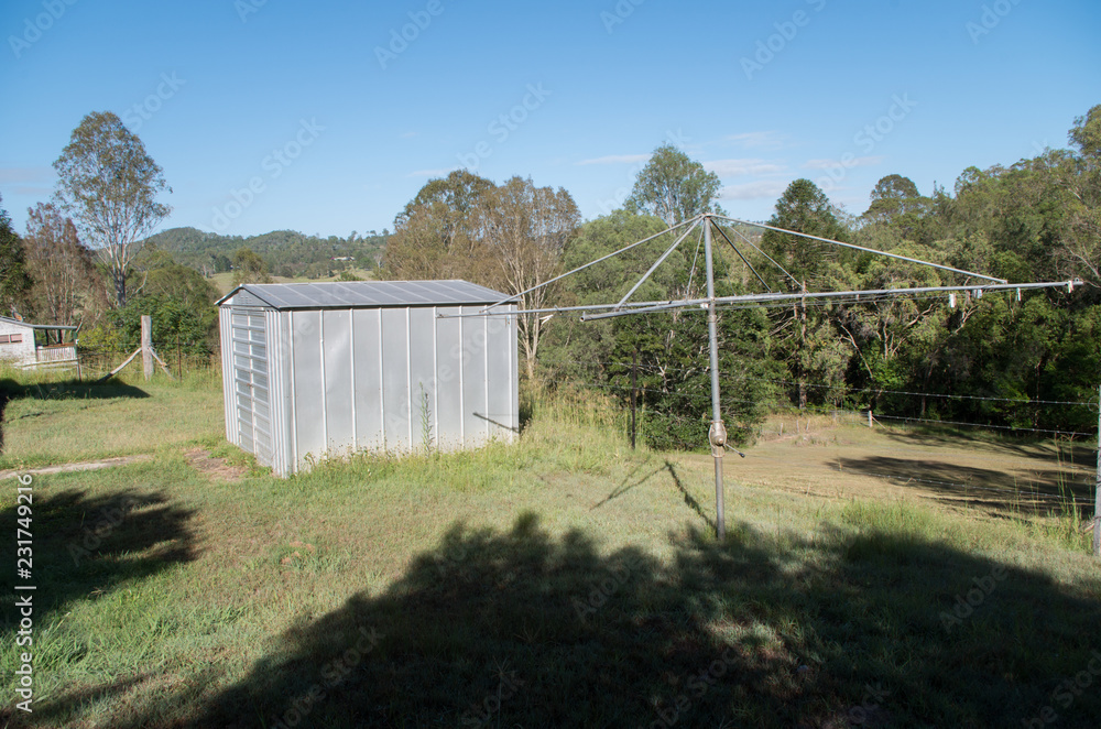 Australian tin shed and rotary clothes washing line Stock Photo | Adobe ...
