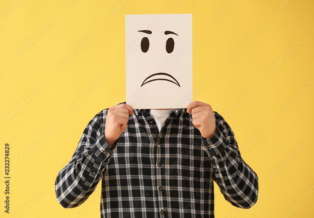 Стоковое фото «Man hiding face behind sheet of paper with drawn ...