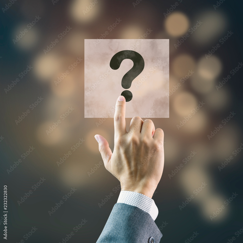 Hand of a man touching question mark by index finger in concept of ...