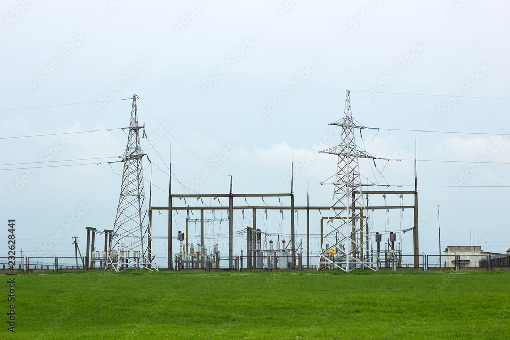 Transformer substation high voltage electrical network in the meadow on ...
