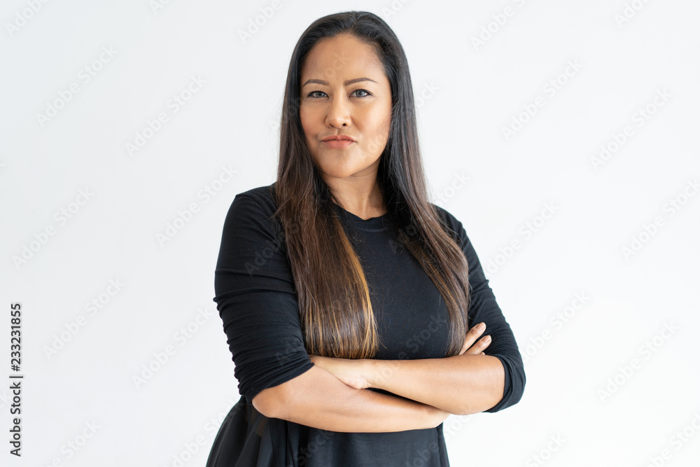 Confident middle-aged woman looking at camera. Strict lady standing ...