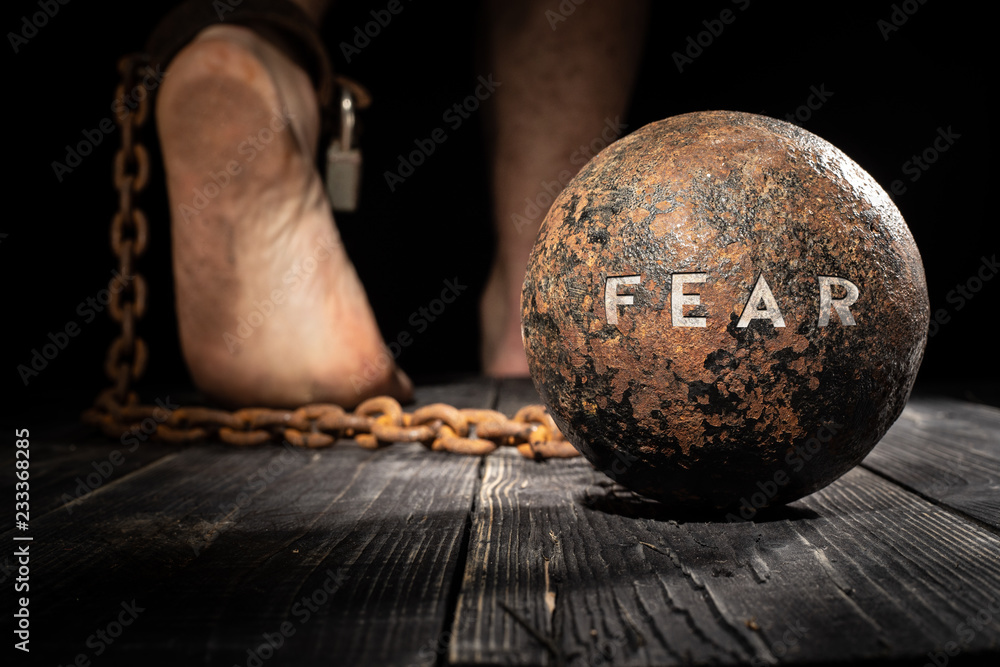 Fear is ball on the leg. Concept of fear. Stock Photo | Adobe Stock