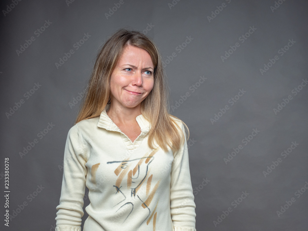Blonde woman pulling funny face making an exaggerated grimace. Adult ...