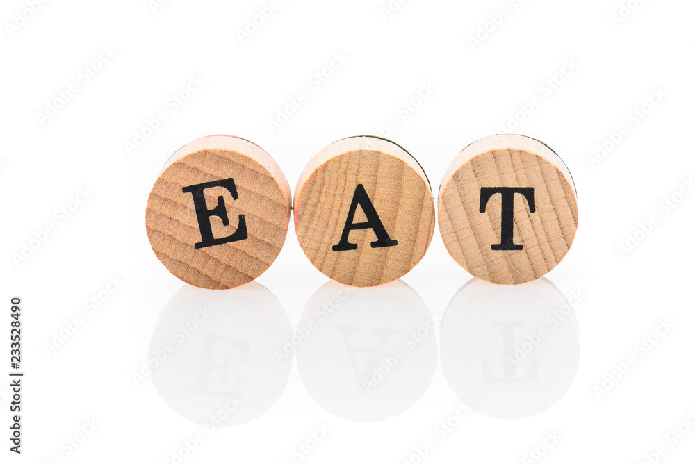 Word Eat from circular wooden tiles with letters children toy. Concept ...