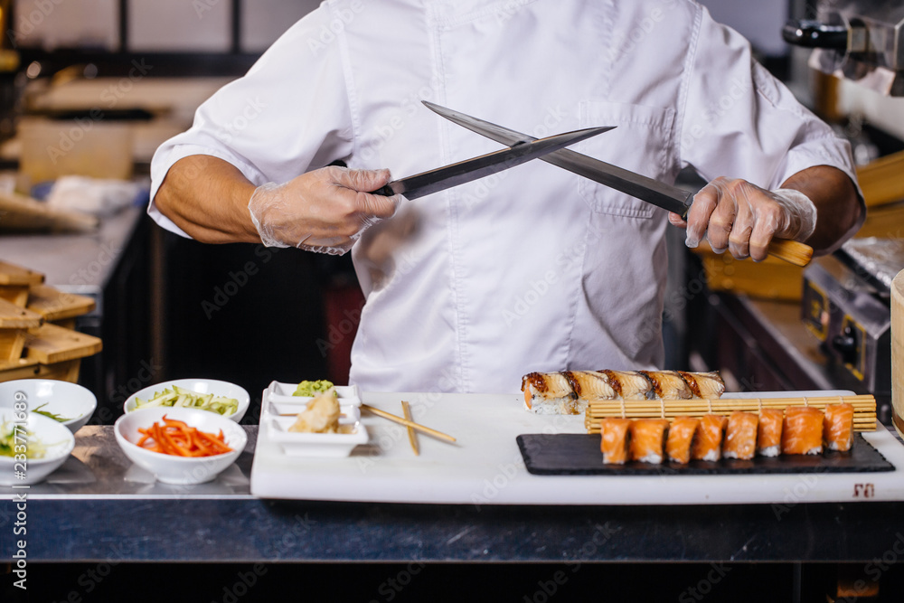 chef's hands with a knife. close up cropped photo. tool for cooking ...