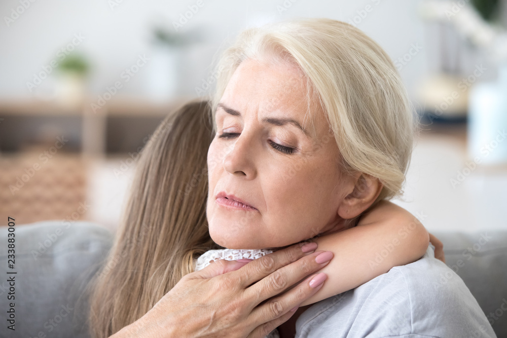 Loving sad grandmother embracing little girl comforting supporting ...