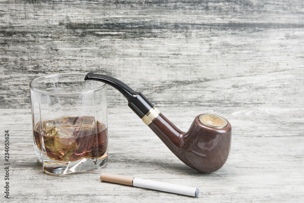 Not a full glass of alcoholic whiskey drink with an e-cigarette on a ...
