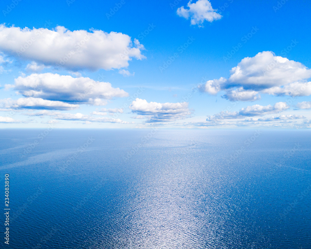 Foto de Stock Aerial view of a blue sea water background and sun ...