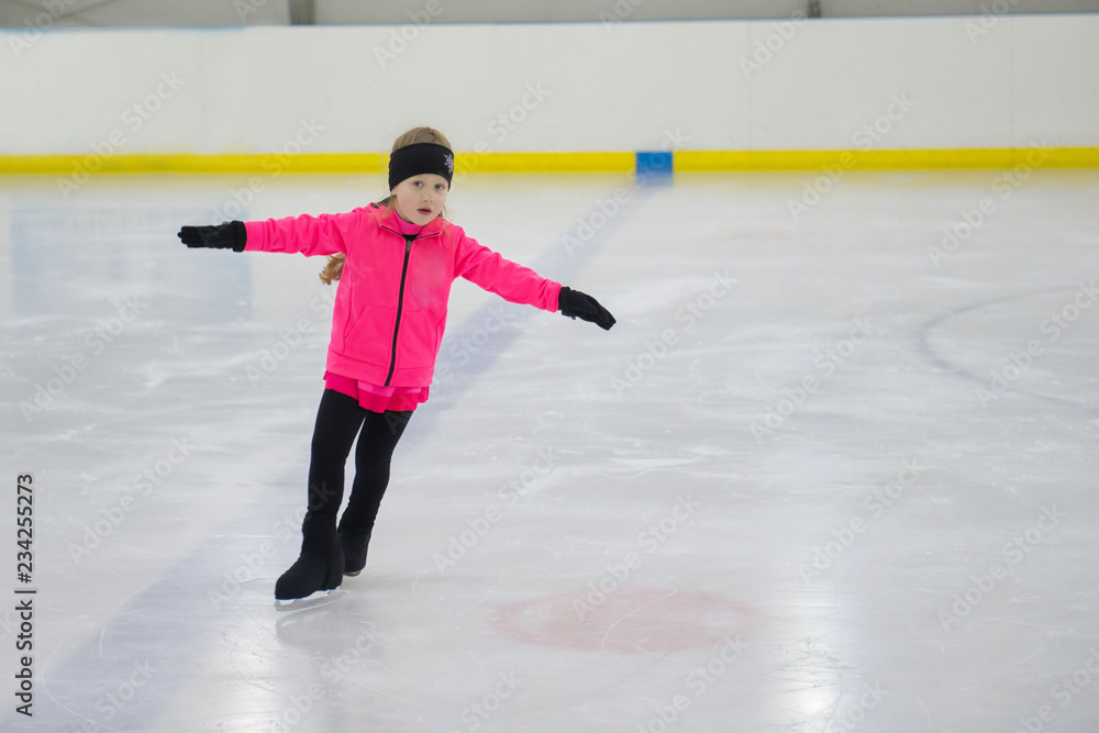 Little girl learning to ice skate. Figure skating school. Young figure ...