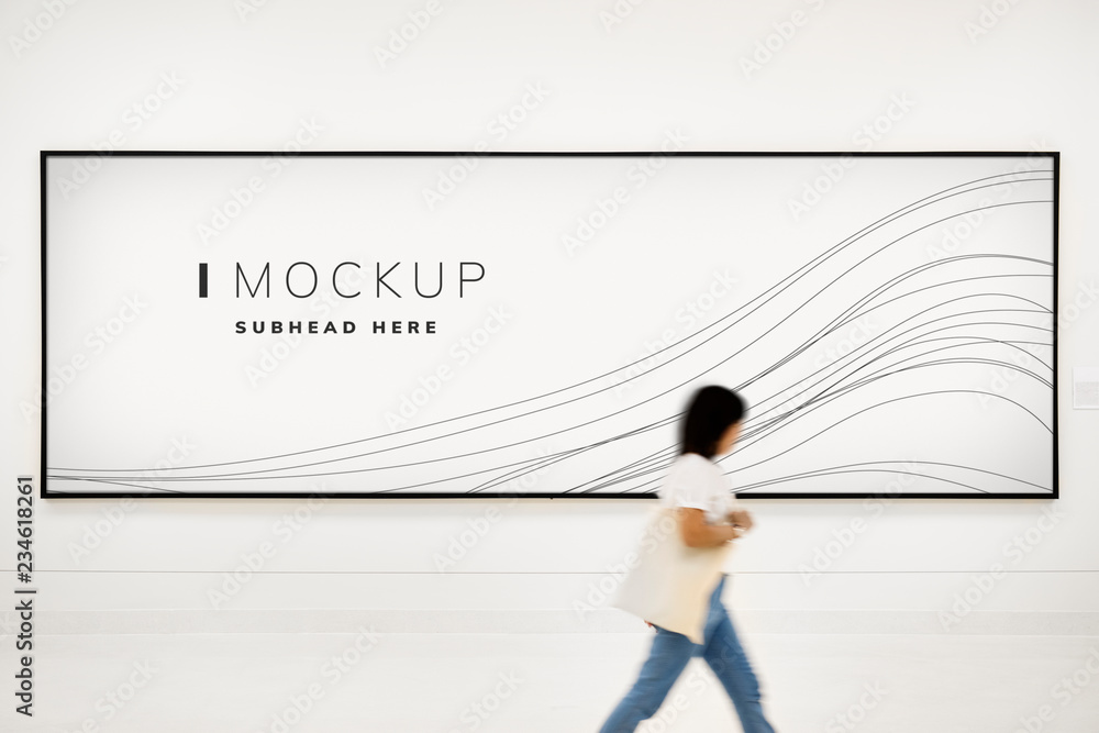 Woman walking pass a signboard mockup Stock Photo | Adobe Stock