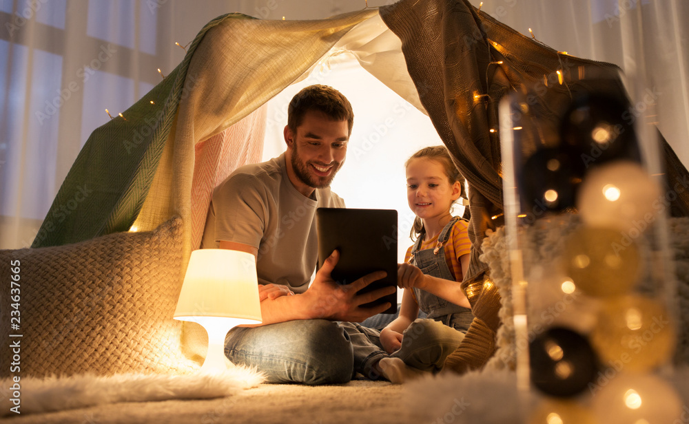 family, hygge and technology concept - happy father and little daughter ...