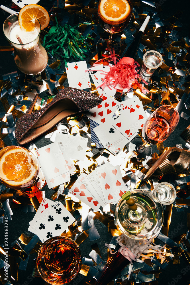 top view of female shoes on high heels, playing cards, alcoholic ...