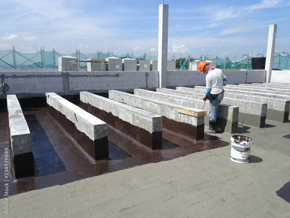 Waterproofing membrane applied by construction workers on top of ...