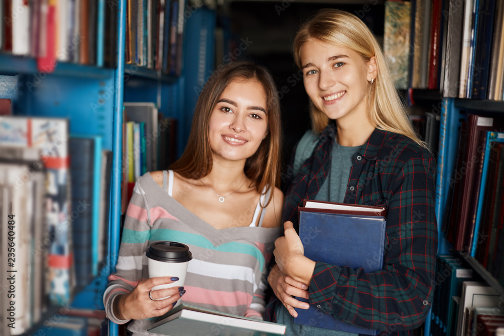 Couple of young female designers come to public library for new ideas ...