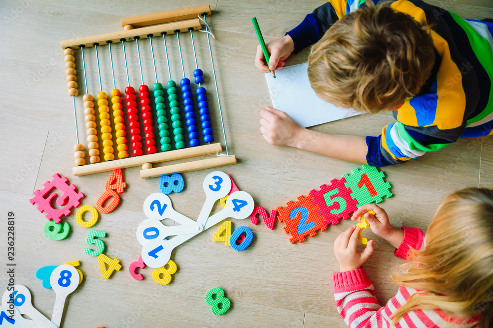 little boy and girl learn to write and calculate numbers Stock Photo ...