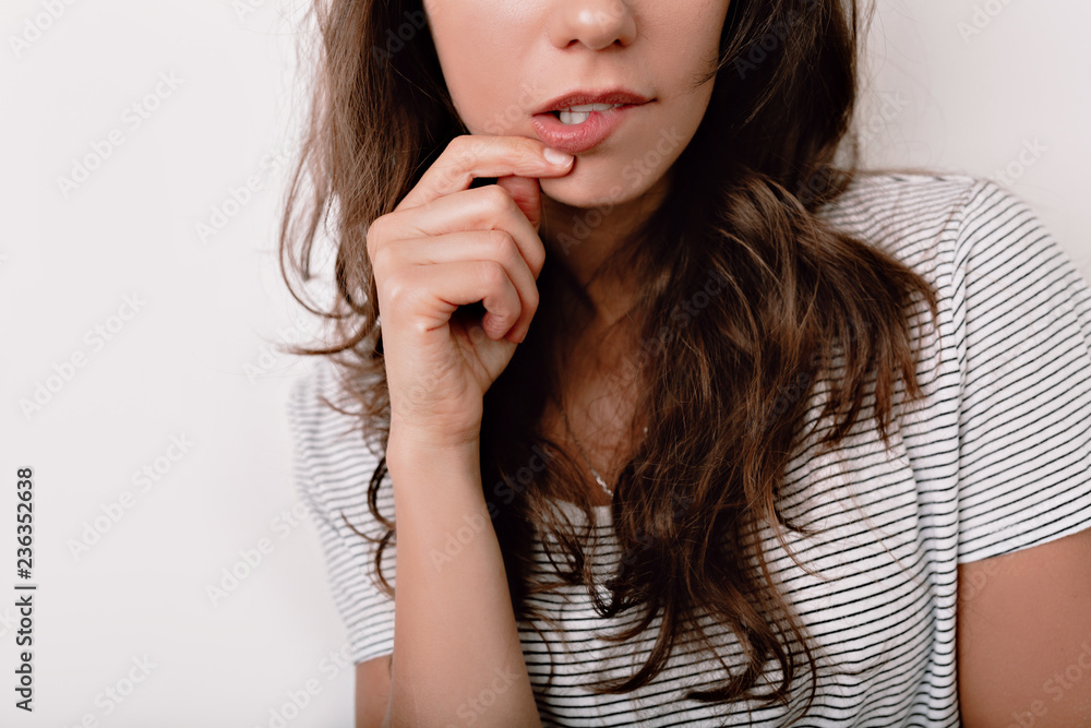 Crop close up portrait of brunette female model bitting her lips and ...