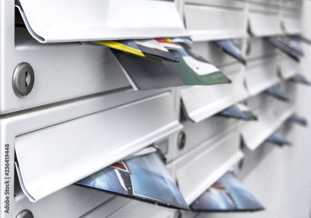 Stock-Foto „Modern mailboxes filled of flyers“ | Adobe Stock