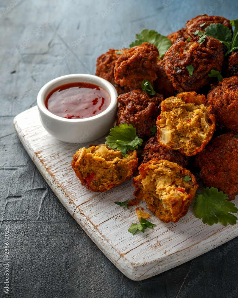 Indian Pakora snack spicy onion, red pepper with chilli sauce on white ...