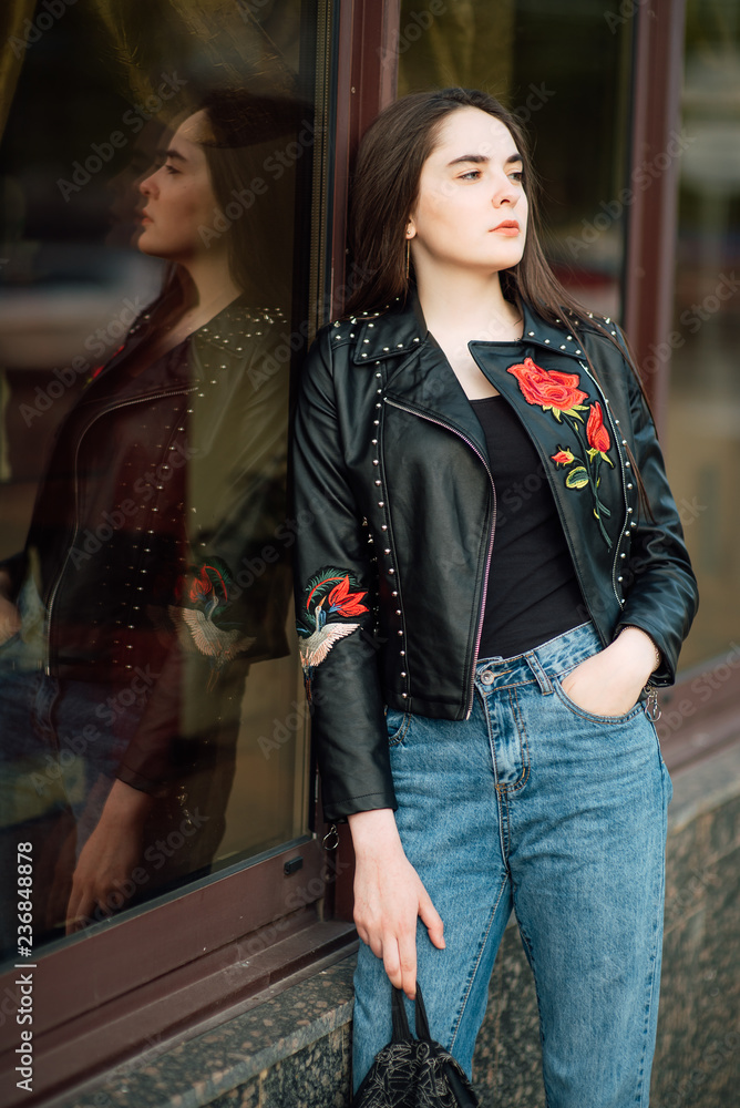 Portrait young punk rock fashion girl in black leather jacket with ...