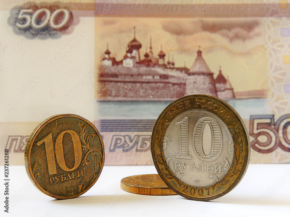 Russian coins 10 rubles are in front of the banknote 500 rubles. The ...