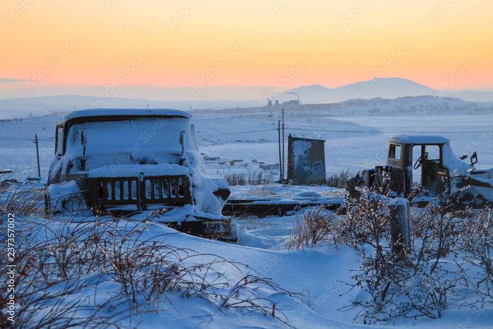 Stock-Foto „Old broken trucks in a car dump in the tundra among the ...