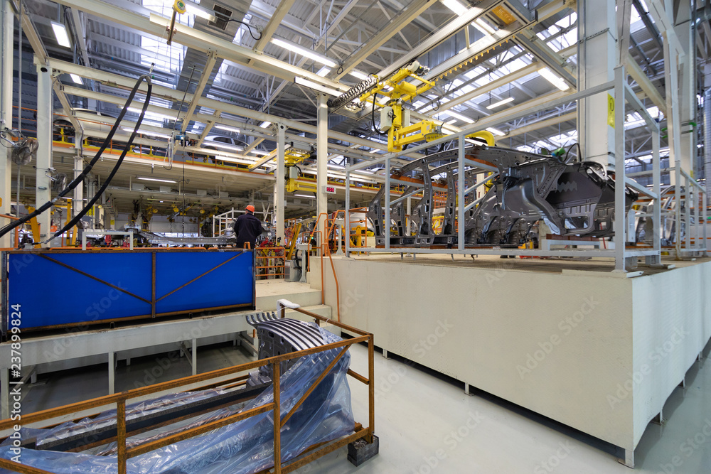 Workers assemble a vehicle body. process of welding cars. Modern ...