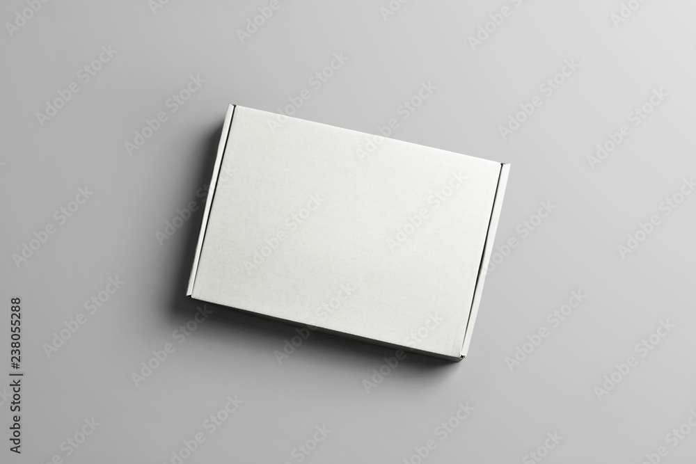 Studio template with closed blank cardboard box of the gray background ...