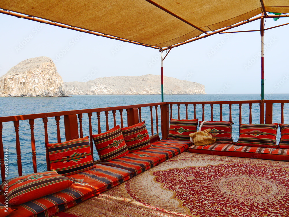 view onside a traditional dhow boat with pillows and carpet cruising ...