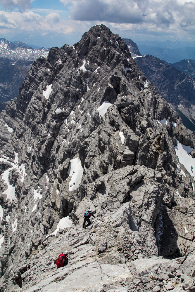Climbers in the via ferrata over the Watzmann ridge to the Middle and ...