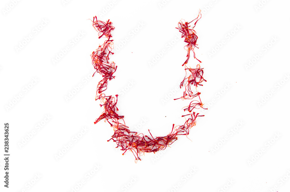 Alphabet made with saffron red gold of sardinia isolated on white clean ...