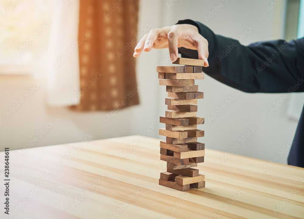 women and teamwork making a pyramid with empty wooden cubes. Business ...