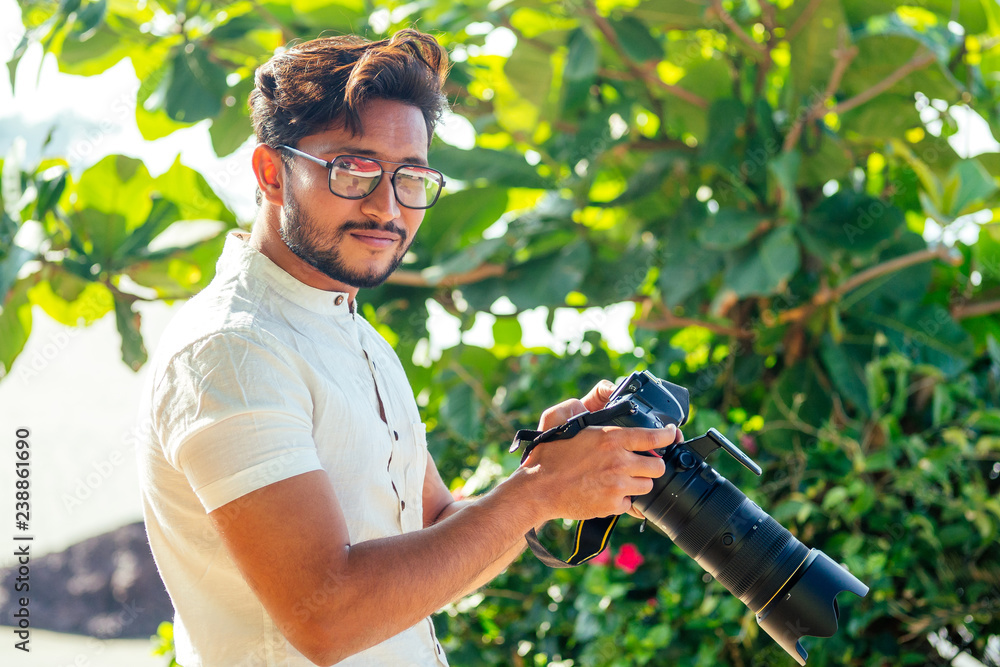 handsome and confident indian man photographer with a large ...