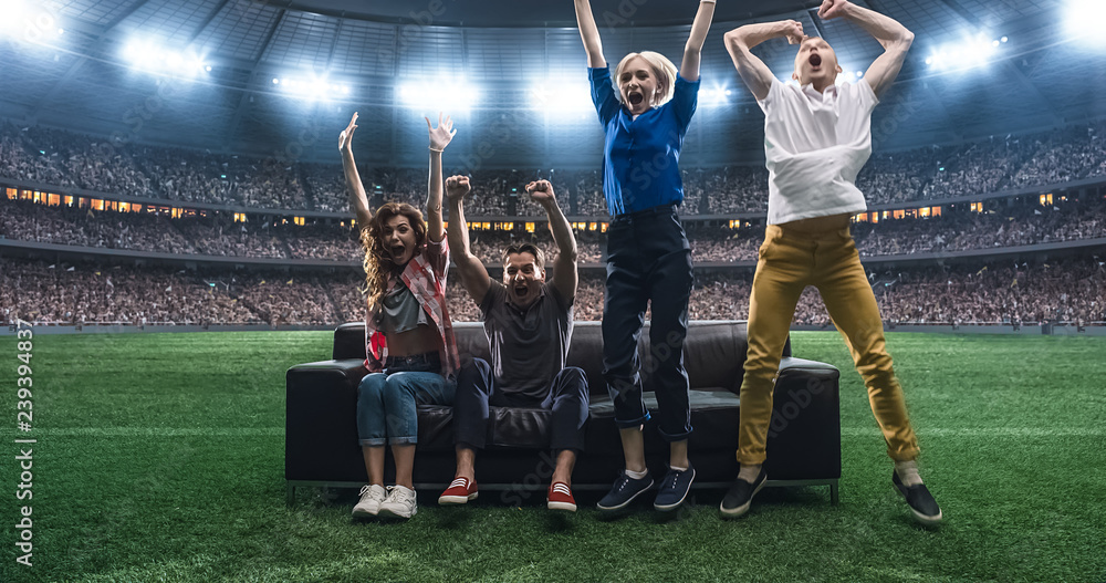 Group of students are watching a football moment, sitting on the couch ...