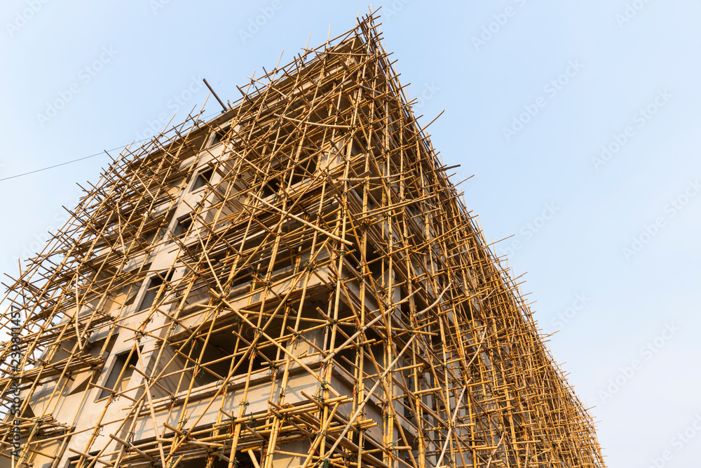 Construction scaffold made from bamboo tree covered the new building ...