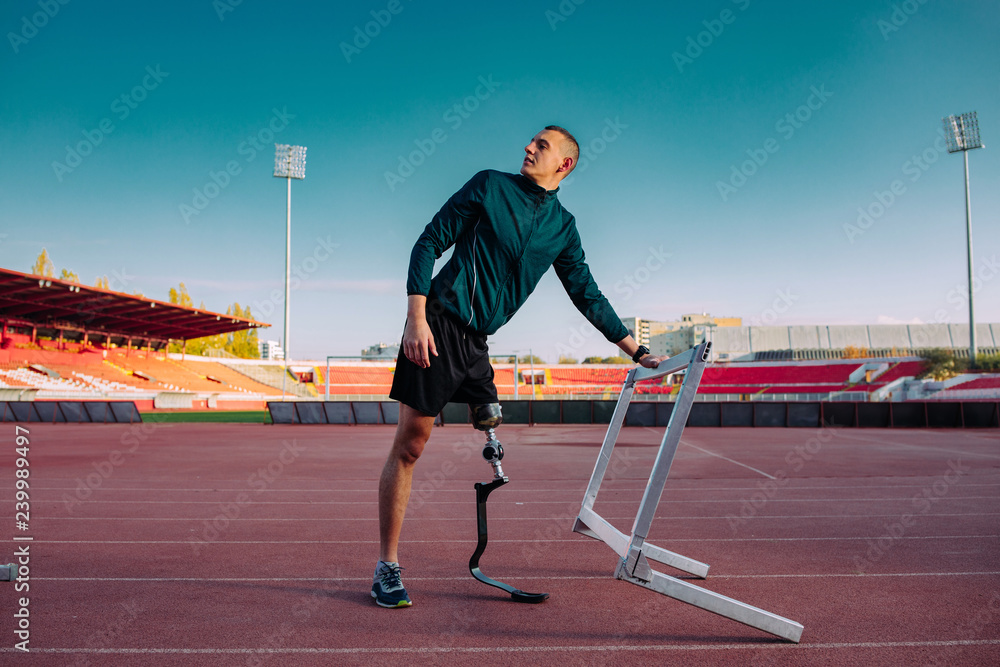 Athlete with prosthetic leg on running track Stock Photo | Adobe Stock