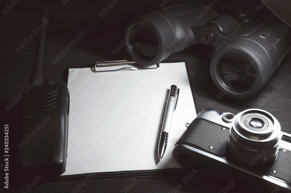 Blank page with copy space, pen, portable radio, binoculars and photo ...