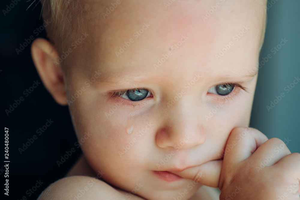 He is a cry baby. Baby with tear rolling down his cheek. Little baby ...