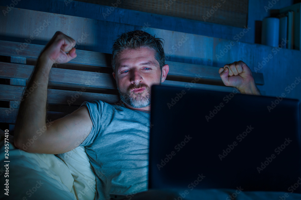 Man Alone In Bed Playing Cybersex Using Laptop Computer Watching Porn Sex Movie Late At Night