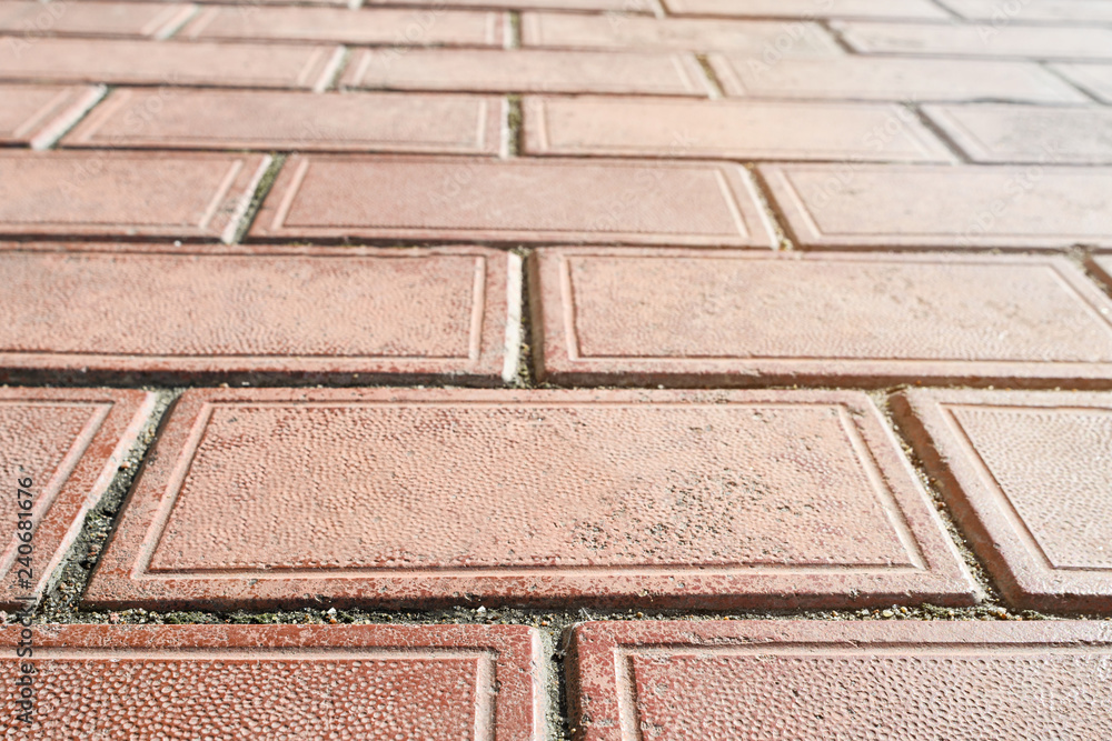 Foto de Stock Red cobblestone with printed texture beaten by time with ...