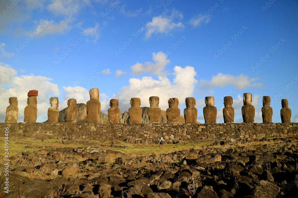 One female tourist taking photos at the back of 15 gigantic Moai ...