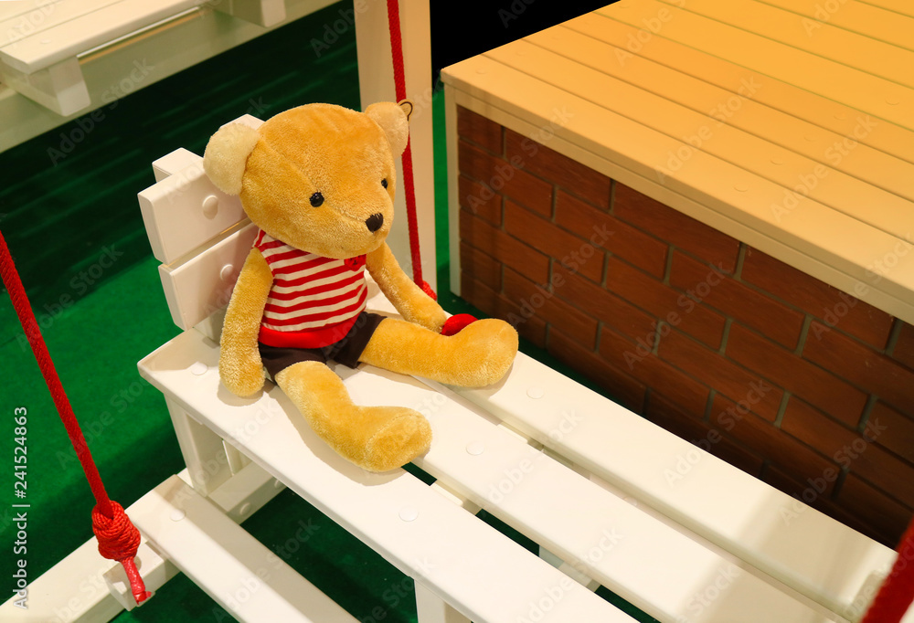 cute teddy sitting on rope wooden swing Stock Photo | Adobe Stock