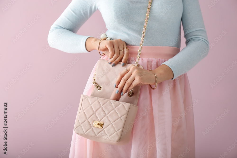 Beautiful woman with stylish accessories and perfume bottle on color ...