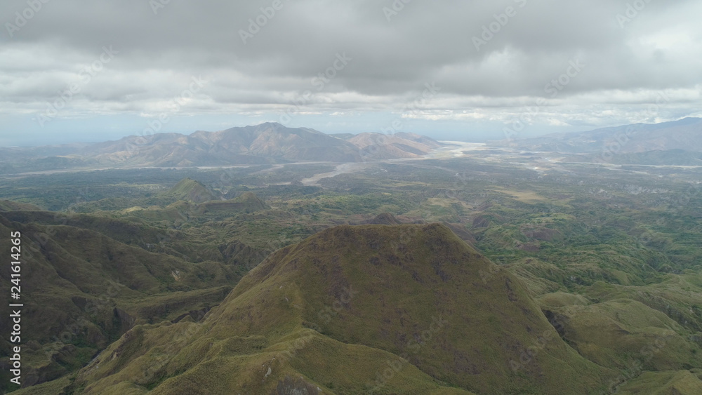 Aerial view of mountains covered with green vegetation, trees in ...