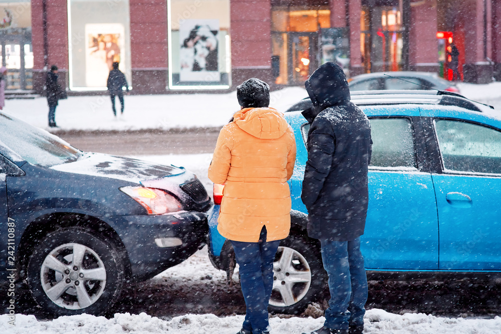 Drivers look at damaged cars after road accident in blizzard. Car crash ...