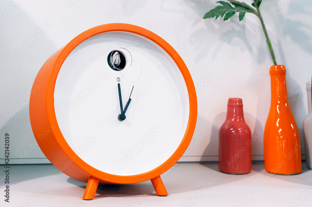 Orange cuckoo alarm clock in modern interior. Stock Photo | Adobe Stock