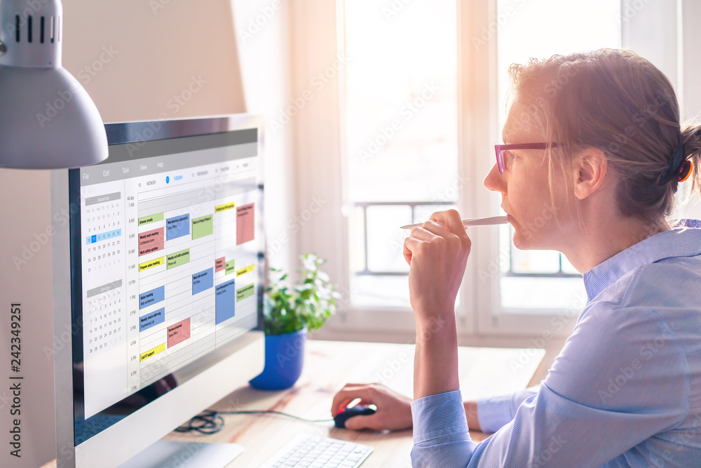 Person using calendar on computer to improve time management, plan ...