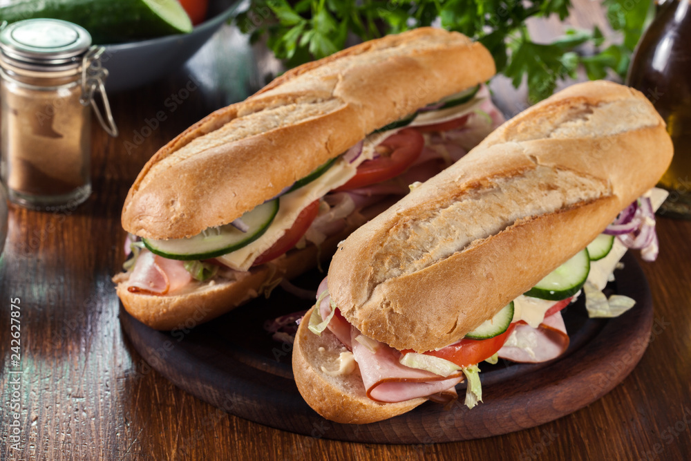 Submarine sandwiches with ham, cheese and vegetables Stock Photo ...