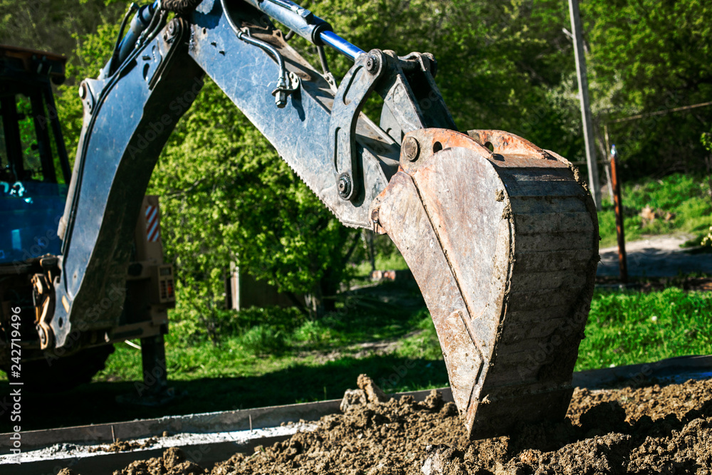 Excavator used for pipe laying works and house foundation. Digging a ...
