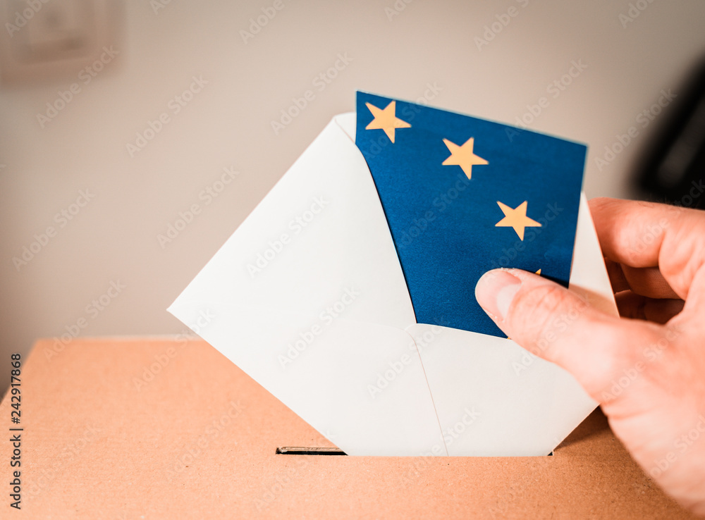 Election in European Union - voting at the ballot box. A hand putting ...