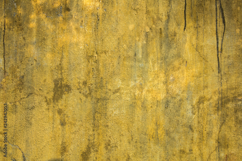 old dirty yellow wall with scratches and black spots. rough surface ...